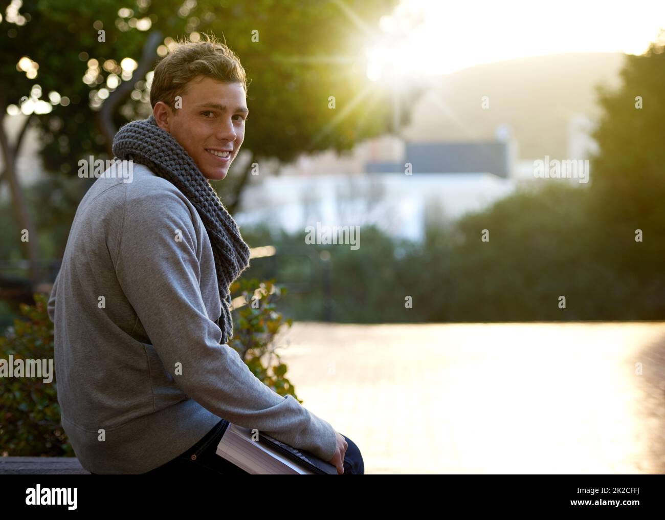 Waiting for my friends. Cropped portrait of a young man on campus Stock ...