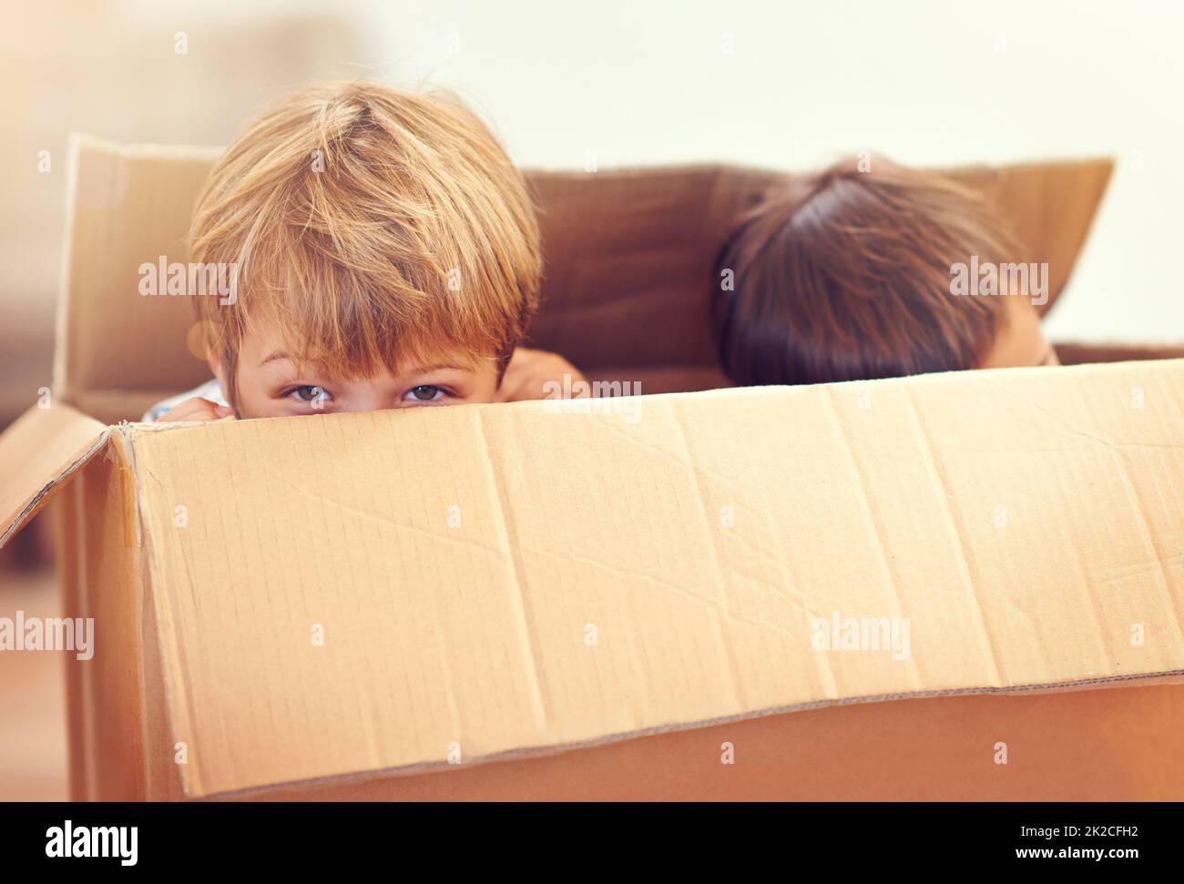 Wanna play a game of peek a boo. Two adorable young boys peeking out of ...