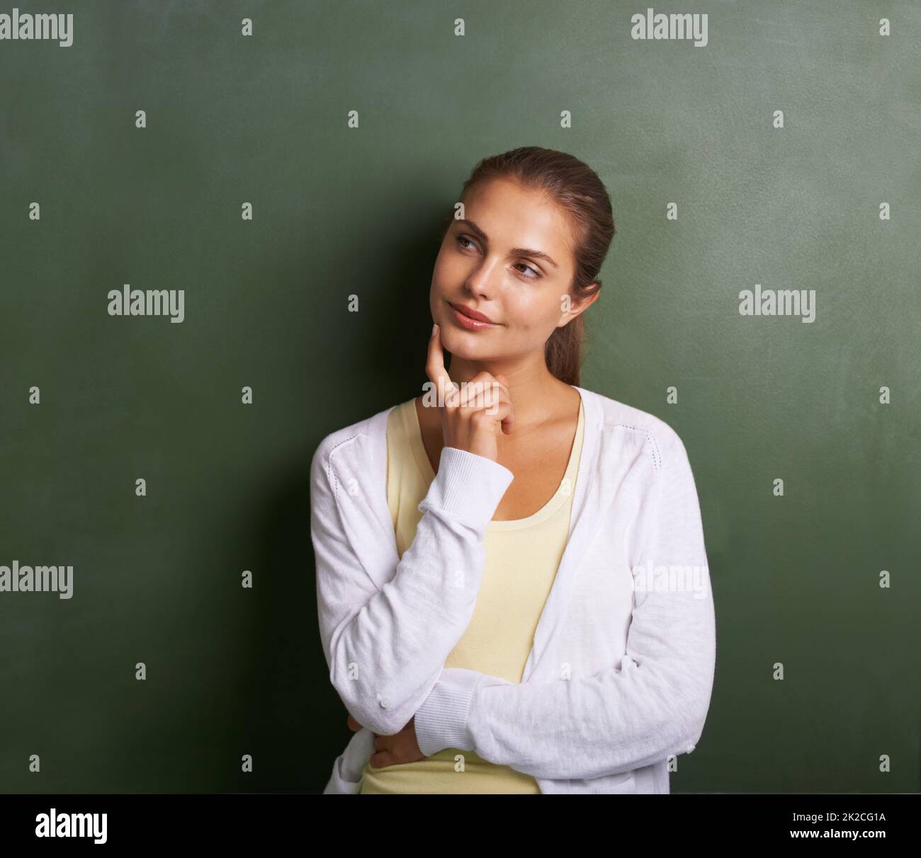 She brings creativity to the classroom. A lovely young teacher standing ...