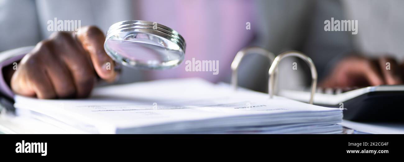 Auditor Using Magnifying Glass For Audit Stock Photo - Alamy