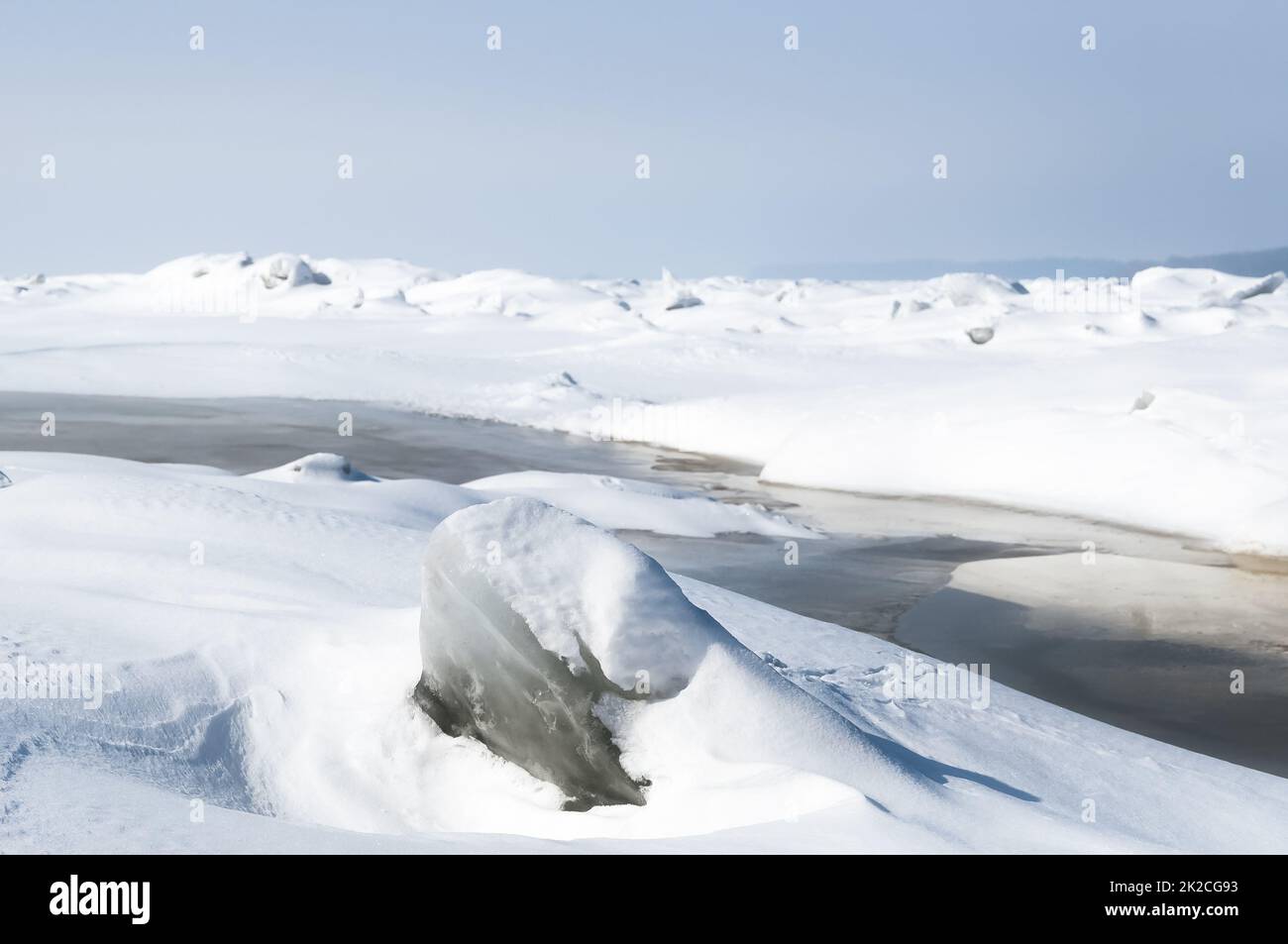 Stunning view of the frozen river covered with chunks of ice and white ...
