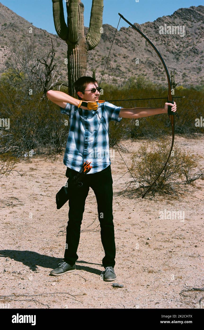 The Traditional Archer with a long bow in the desert Stock Photo - Alamy
