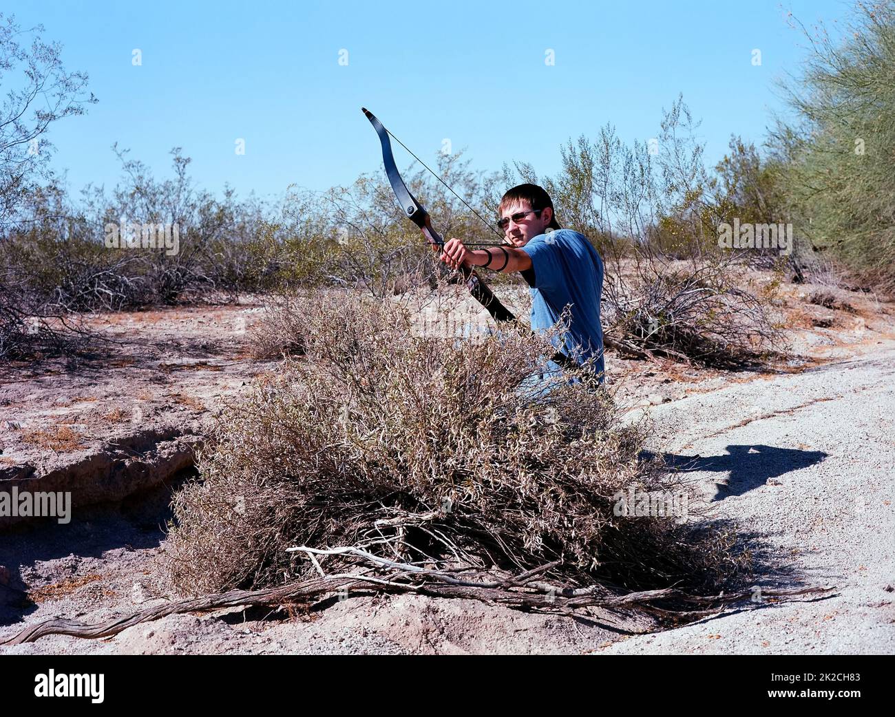 The Traditional Archer shooting a recurve bow in the desert Stock Photo ...