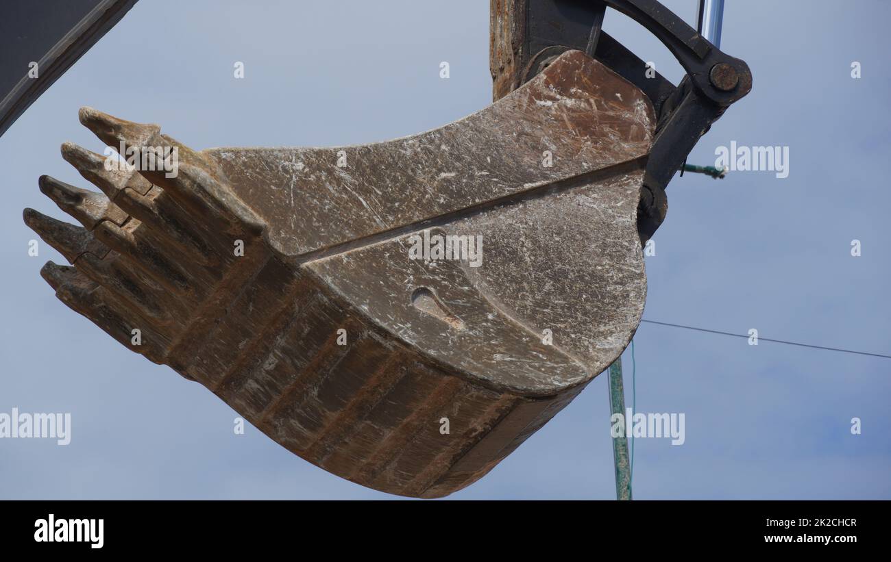 Excavator Loader standing against blue sky Stock Photo - Alamy