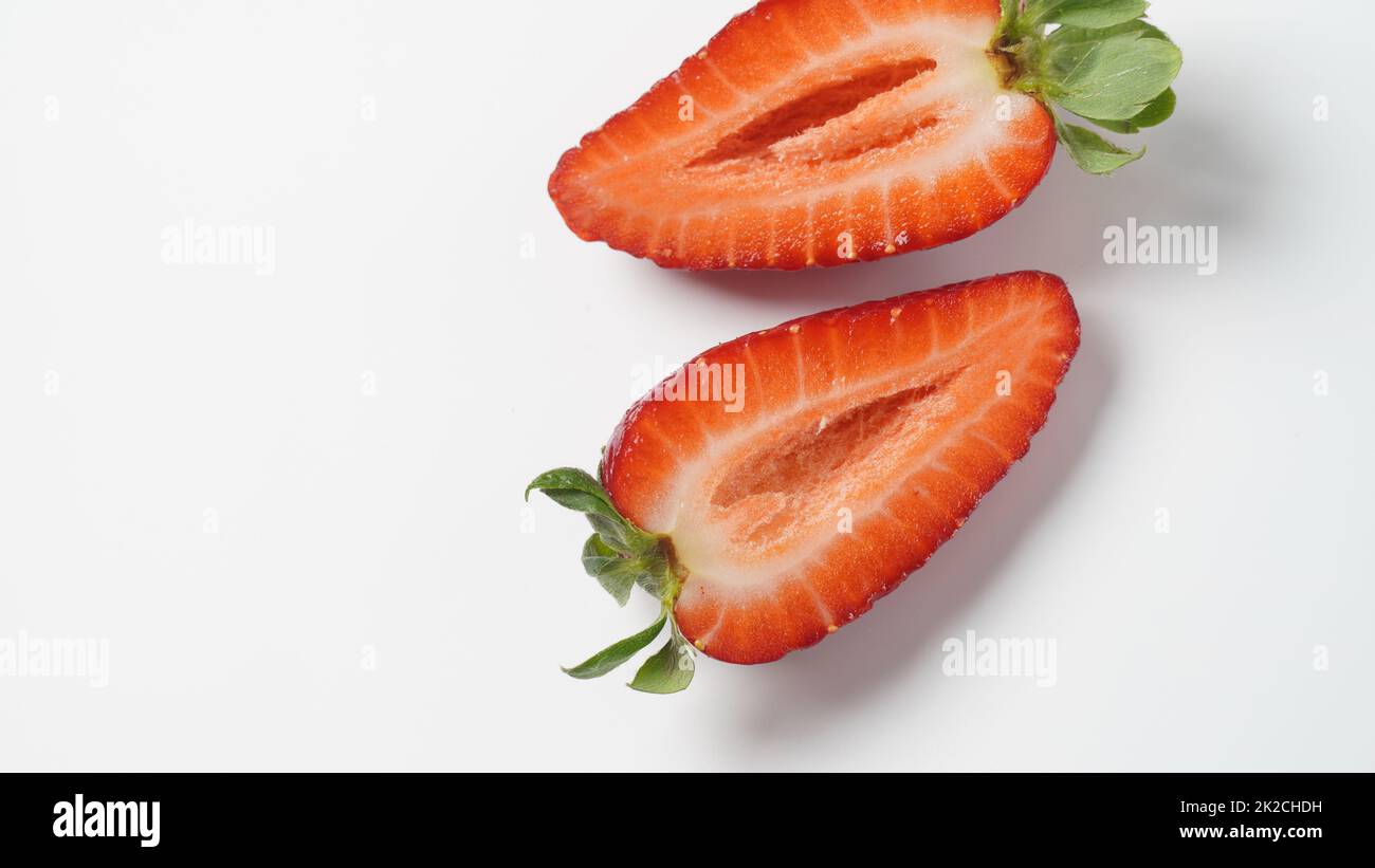 Sweet fresh strawberry halves cut on white background Stock Photo - Alamy