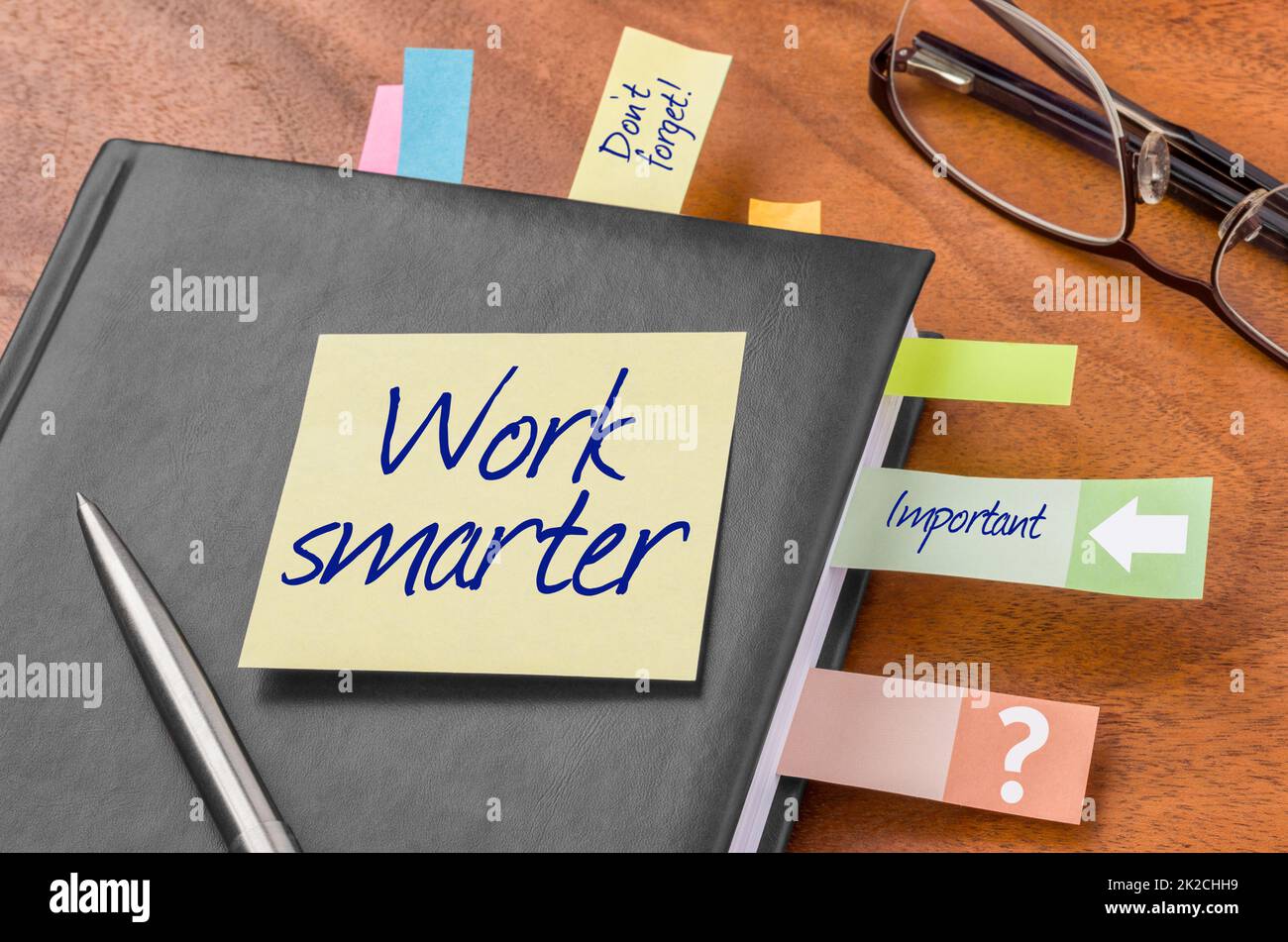 Planner with sticky note - Work smarter Stock Photo - Alamy