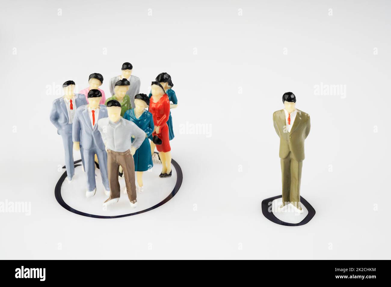 A group and a single miniature models isolated within a circle drawn on ...