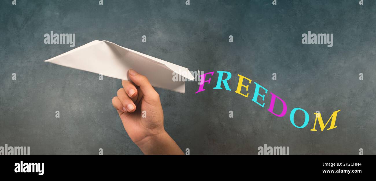 Holding an airplane in the hand, fly to freedom, back to normal concept ...