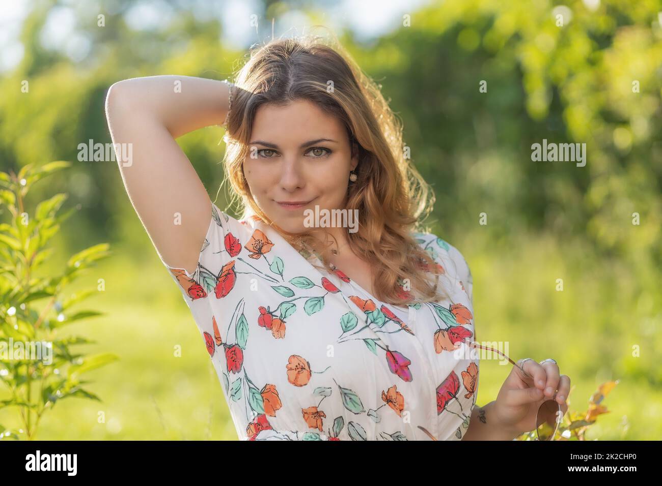 Atractive long hair young woman is posing outdoors Stock Photo - Alamy