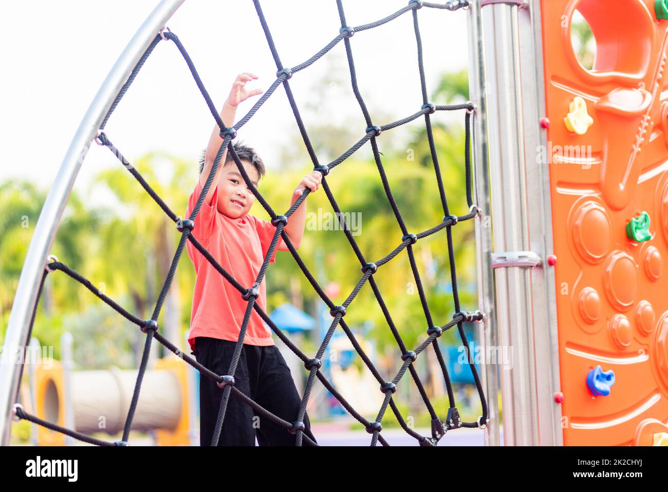 Asian child smiling playing climbing outdoor playground Stock Photo - Alamy