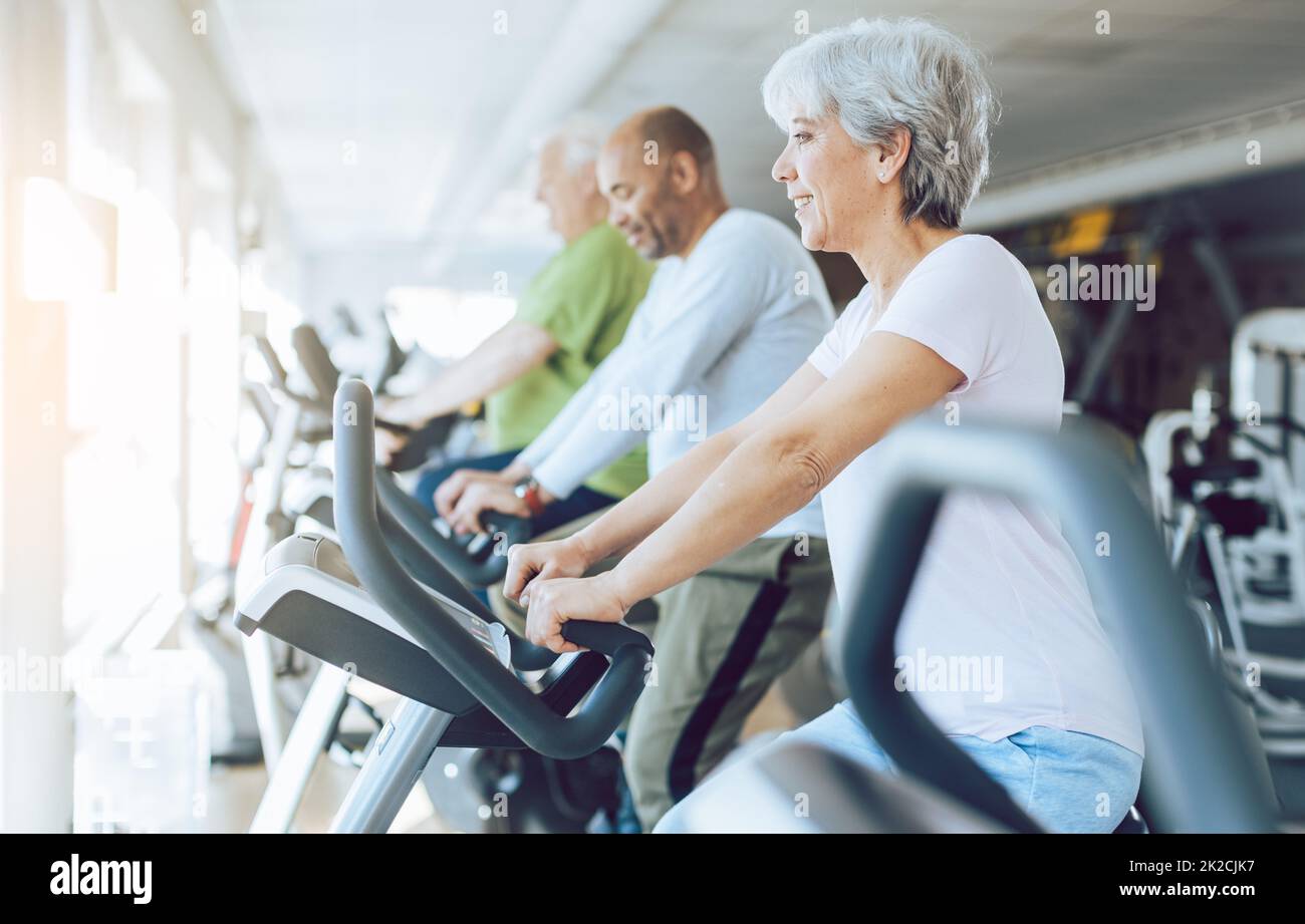 Fit seniors on stationary fitness bikes in the gym Stock Photo - Alamy