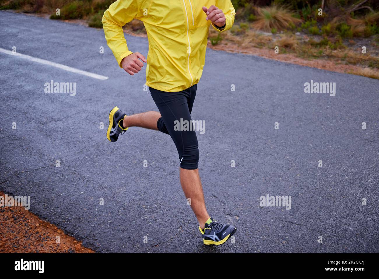 Let the road fly beneath your feet. High angle view of an athletes body ...
