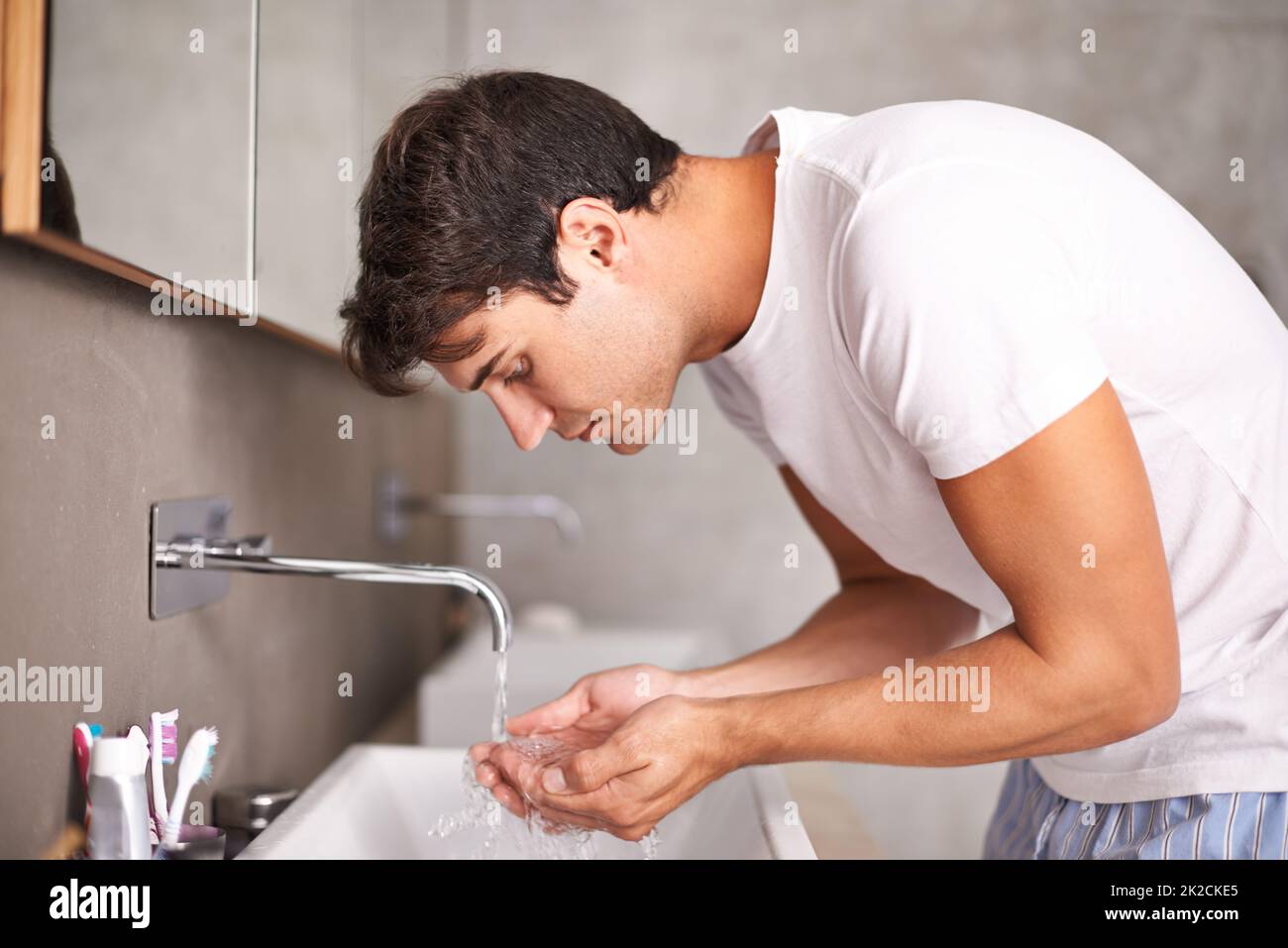 Young man washing hands hi-res stock photography and images - Alamy