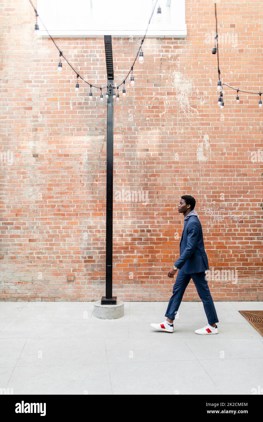 Man walking along wall hi-res stock photography and images - Alamy