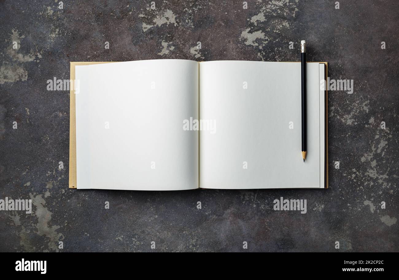 Open book, pencil Stock Photo - Alamy