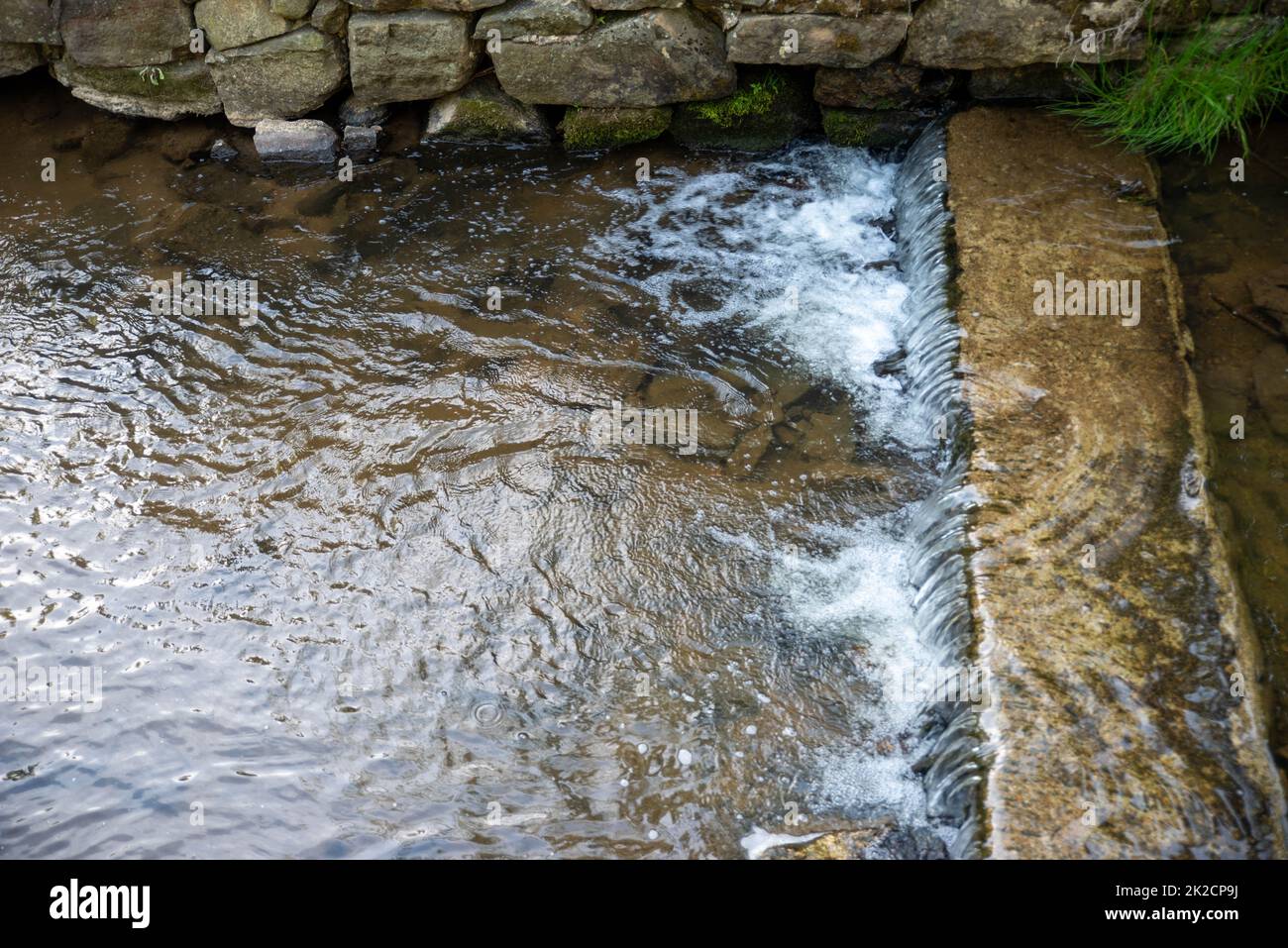 water cascasdes over an old stone dam in old channel Stock Photo - Alamy