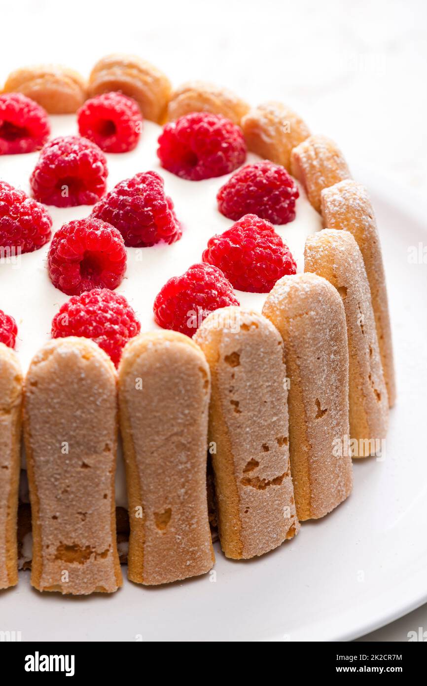 raspberry cream cake with Italian sponge cakes around Stock Photo - Alamy