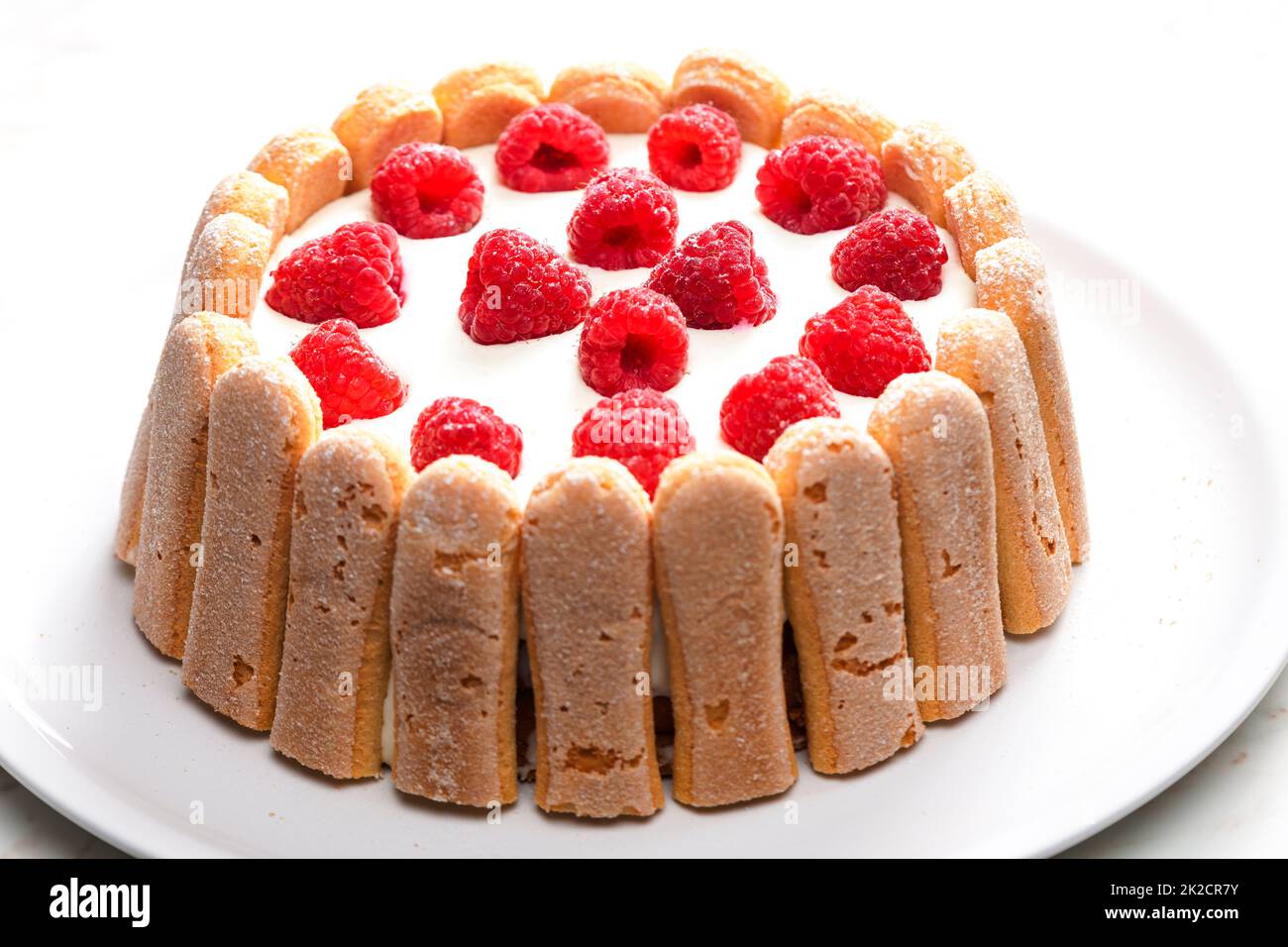 raspberry cream cake with Italian sponge cakes around Stock Photo - Alamy