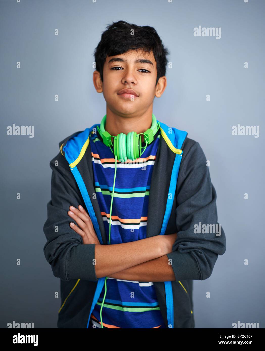 That kids got a ton of confidence. Studio shot of a young boy looking ...