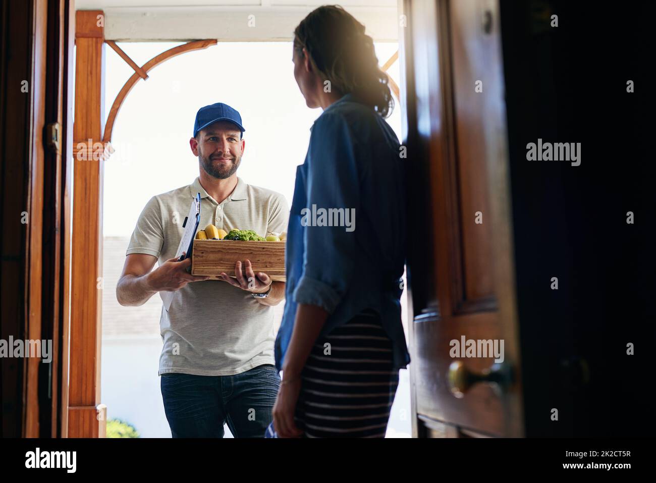 Women delivering groceries to man hi-res stock photography and images ...