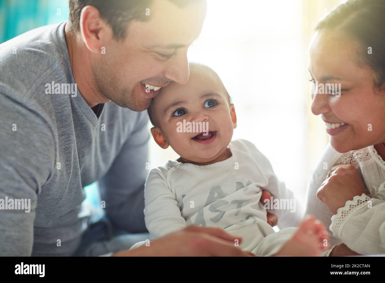 Born into a home full of love. Shot of an adorable baby boy bonding ...