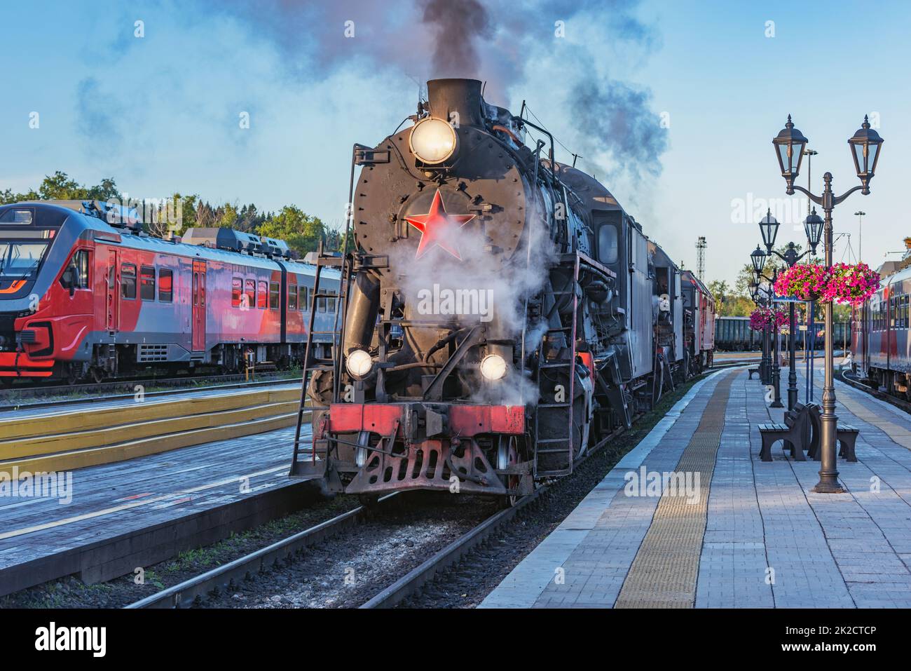 Steam locomotives stand by the wooden station platform Stock Photo - Alamy