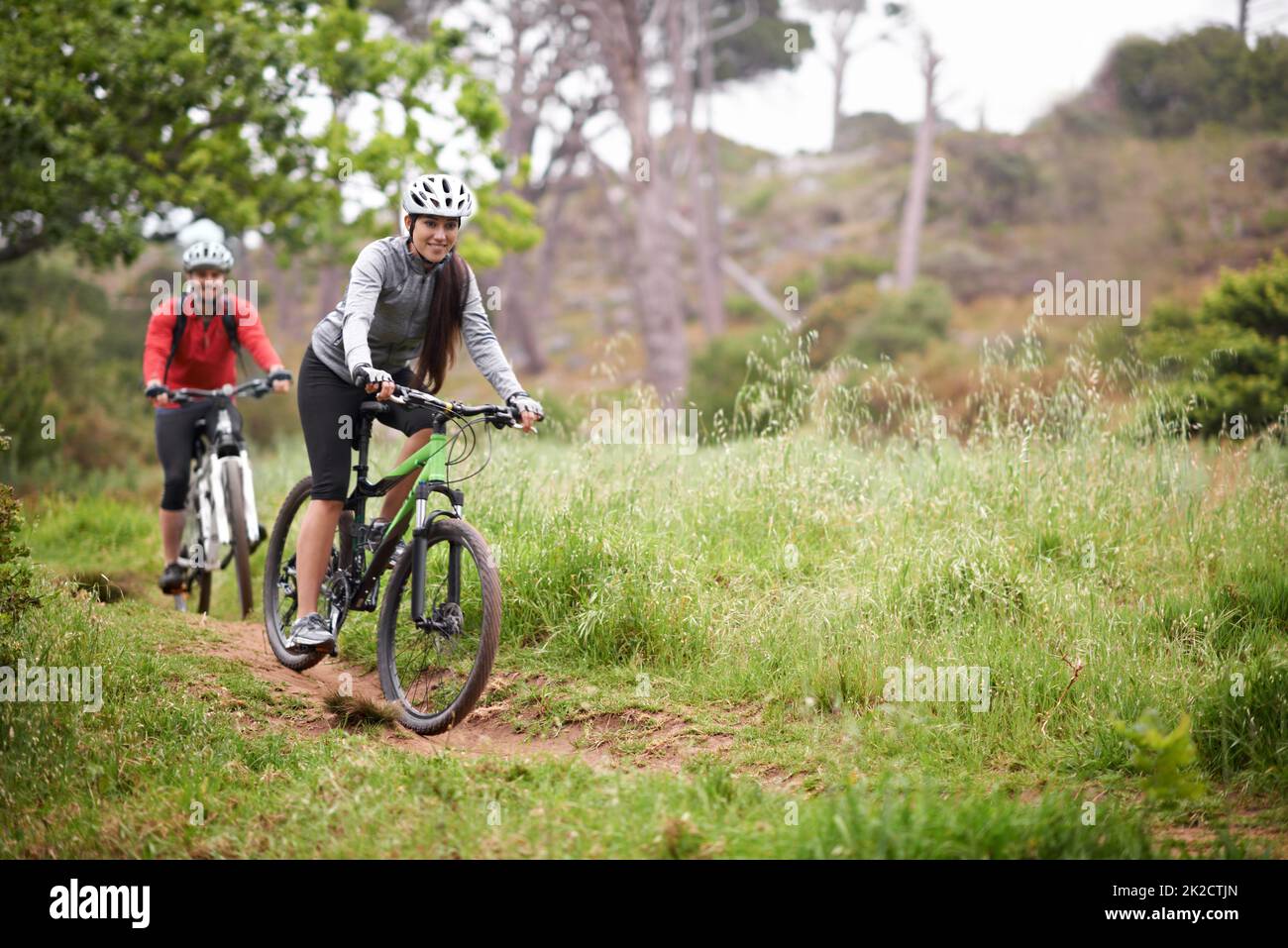 Exploring the roads less travelled. A pair of young cyclists enjoying ...