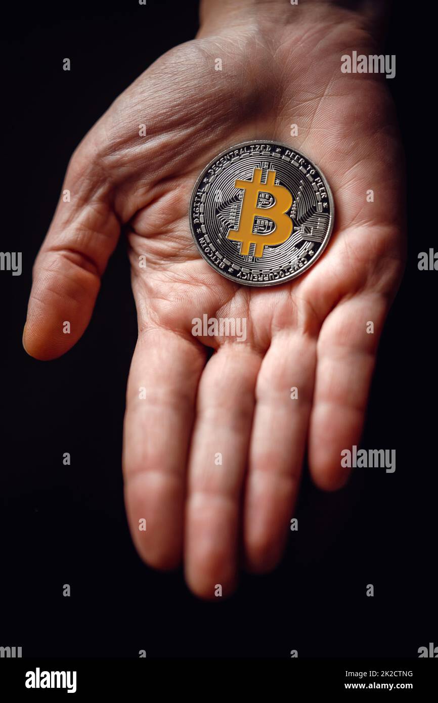 Bitcoin silver coin hand hi-res stock photography and images - Alamy