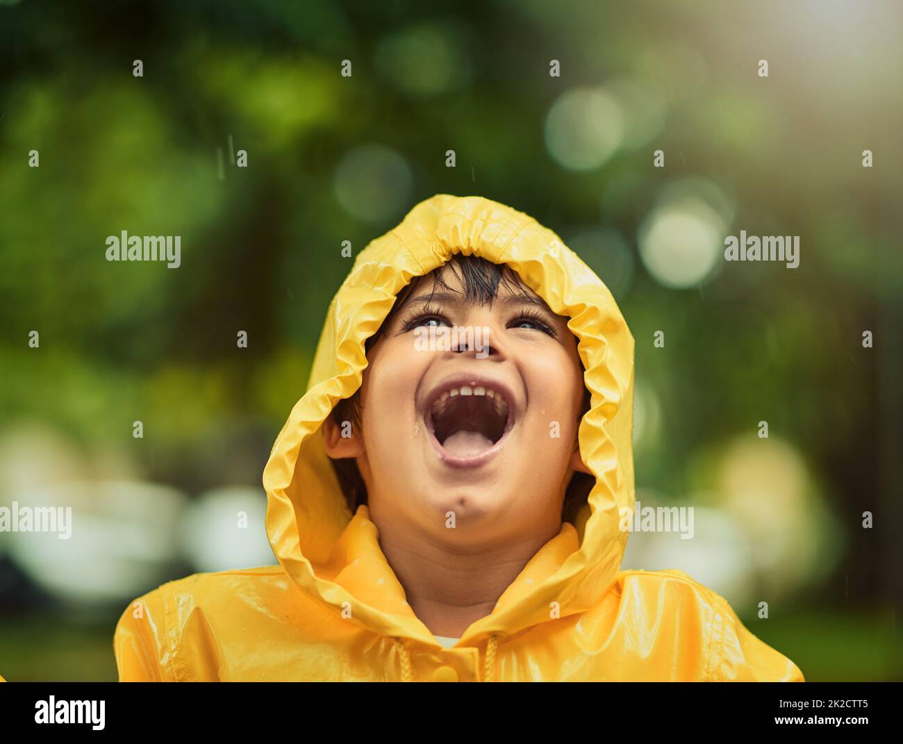 There is so much fun to have in the rain. Cropped shot of an adorable ...