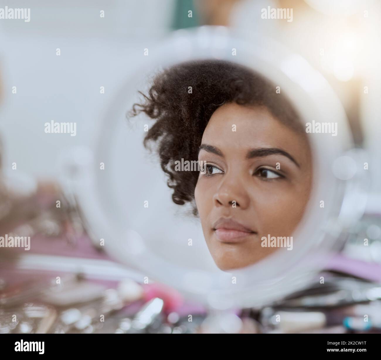 In the vanity. Cropped shot of a reflection of an attractive young ...