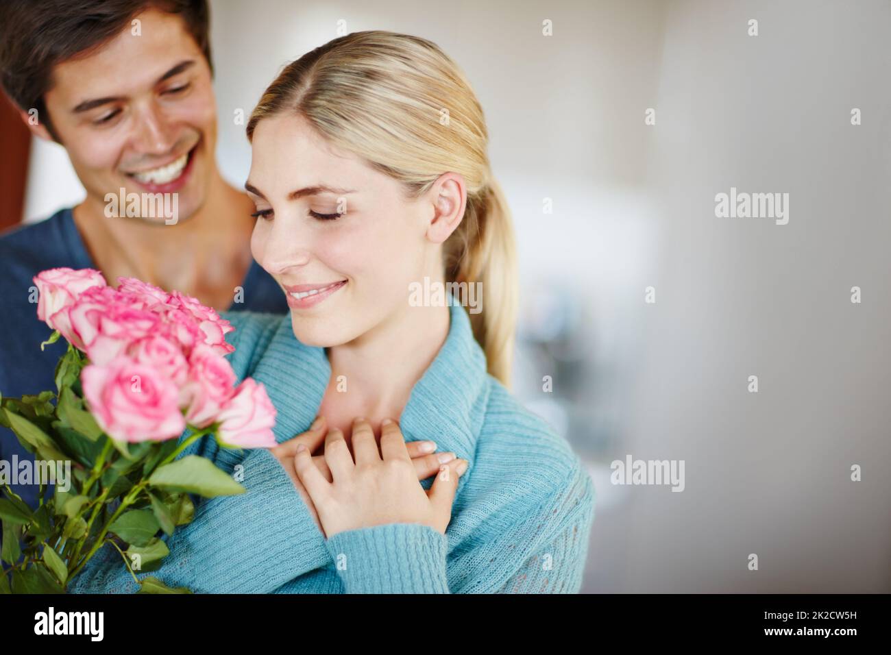 Give her roses just because. Shot of an affectionate young man giving ...