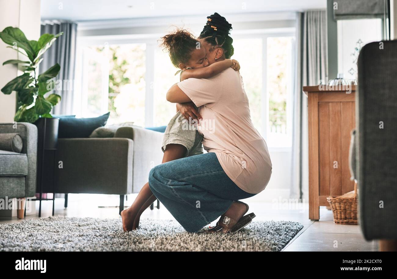 Hug it out. Shot of a mother and child hugging at home Stock Photo - Alamy