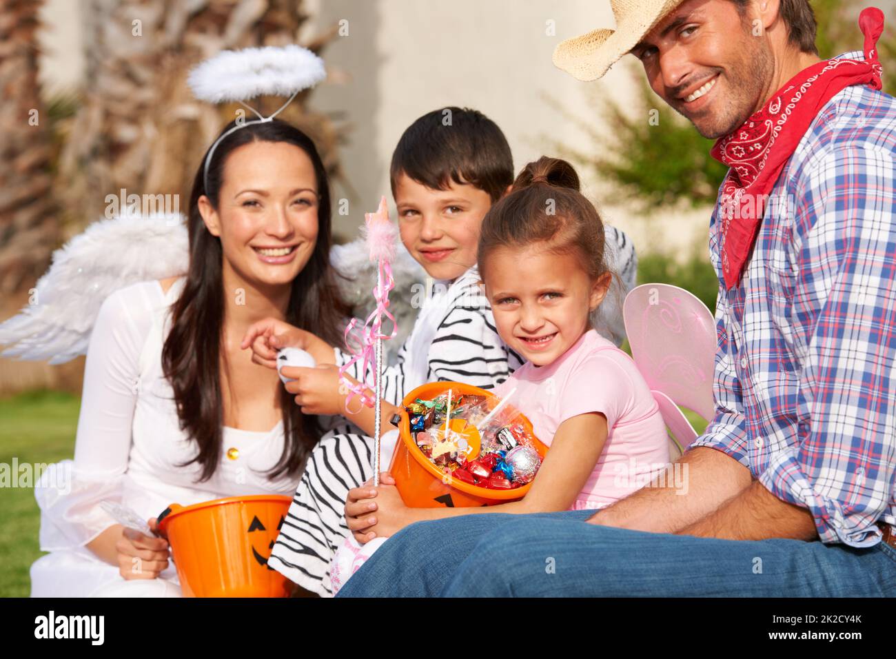 Trick-or-treating as a family. Cropped shot of a family out the treats ...