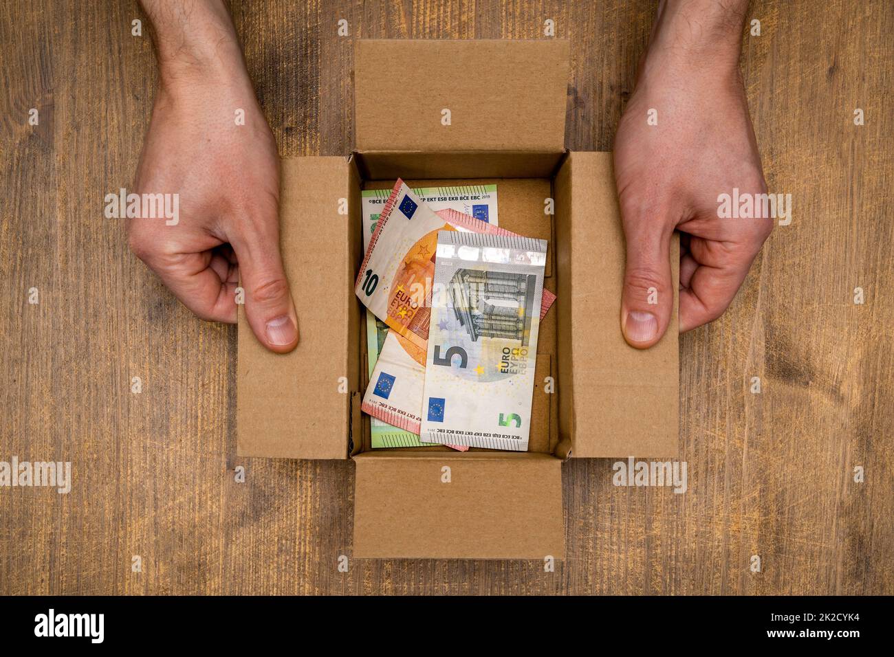 Euro banknotes in open box made from corrugated cardboard Stock Photo ...