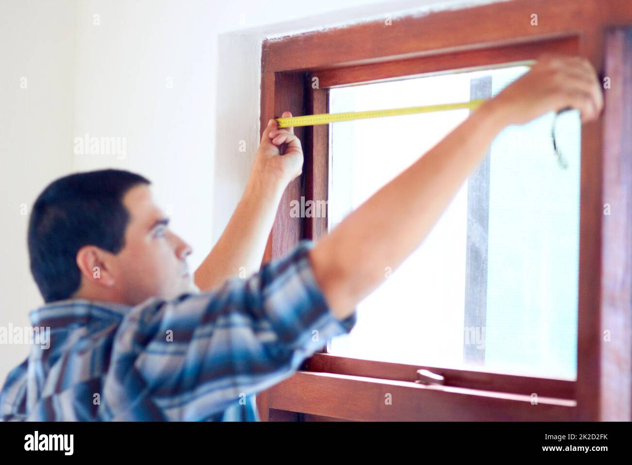 The exact measurement. Shot of a middle aged handy man measuring a ...