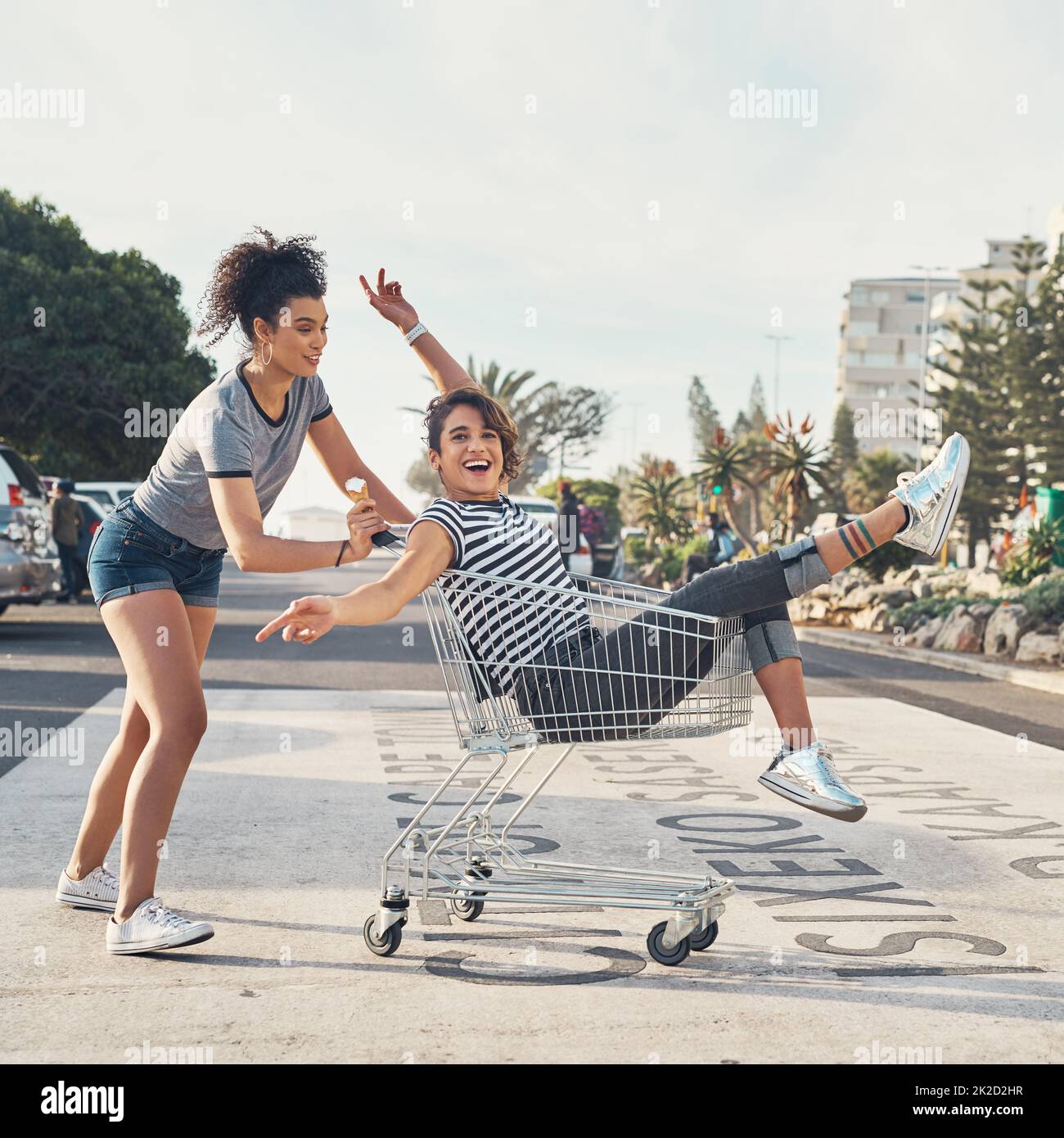 Good friends keep the bad days at bay. Shot of a young woman pushing ...