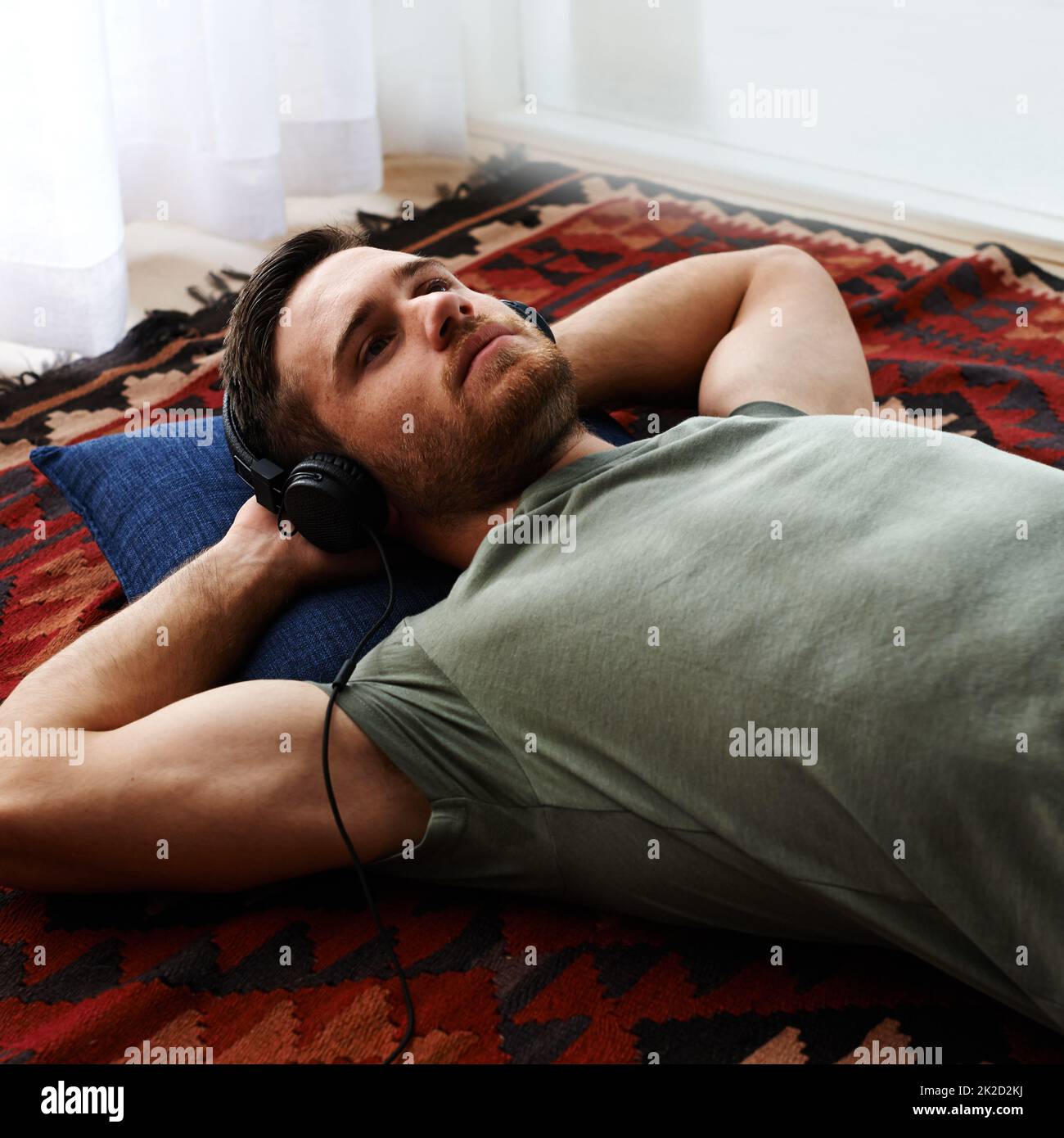Man listening music lying on hi-res stock photography and images - Alamy