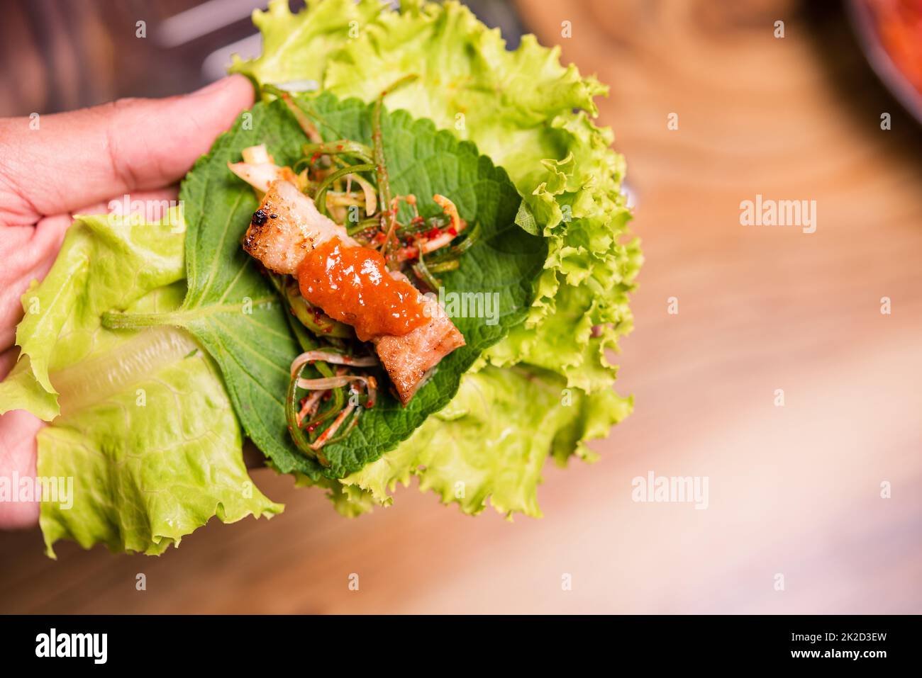 grilling meat wrap green vegetable leaf for eat at restaurant Stock ...