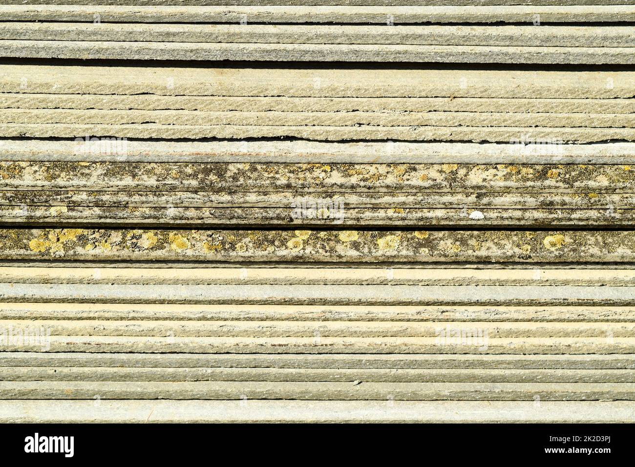 Corrugated slate lies in a pile, side view background texture of slate ...