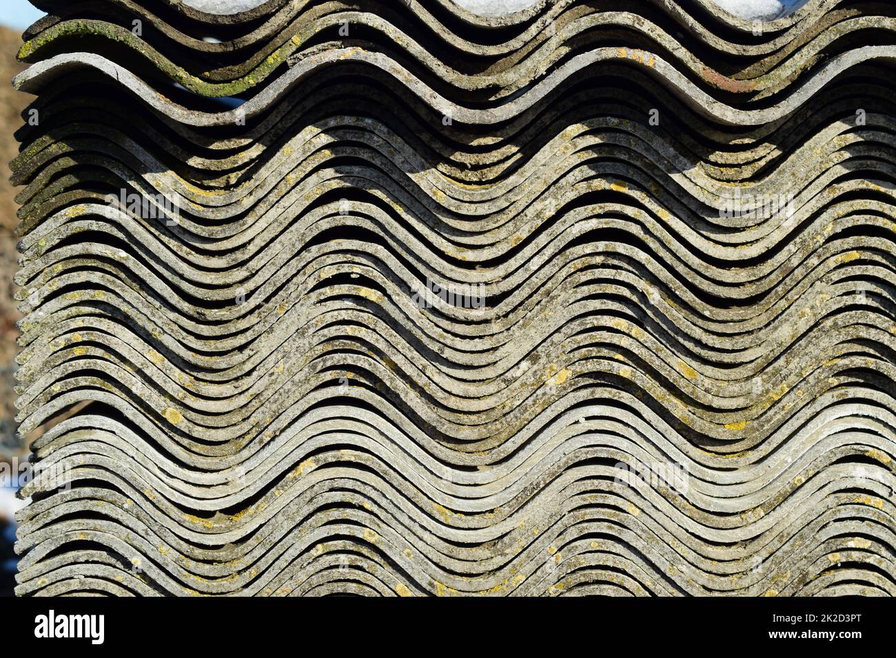 Corrugated slate lies in a pile, side view background texture of slate ...