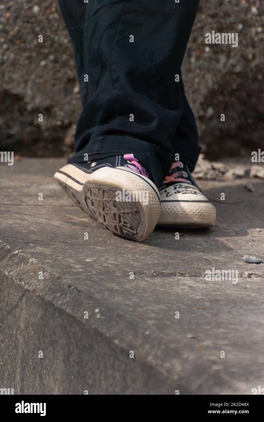 Shoes of a alternative punk emo girl standing on concrete wall Stock ...