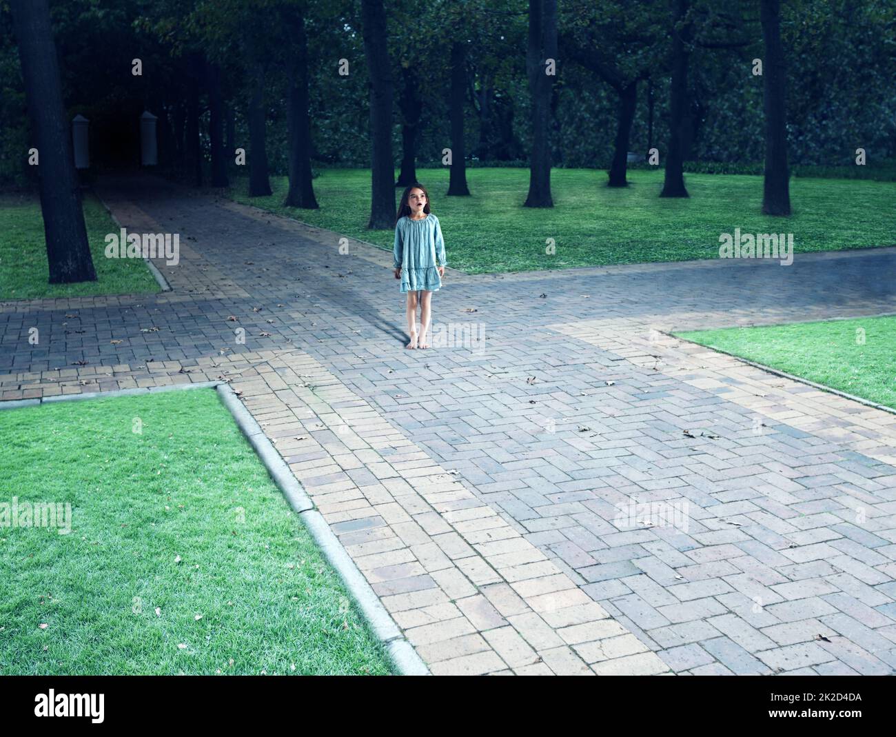 Shot of a child standing in the centre of a four way intersection in ...