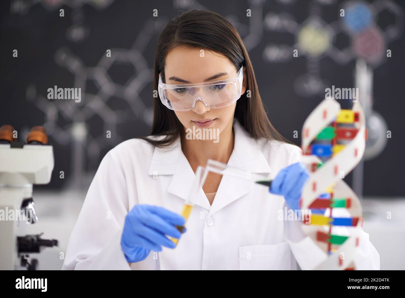 Advancement in genetics improving life. Shot of a female scientist ...