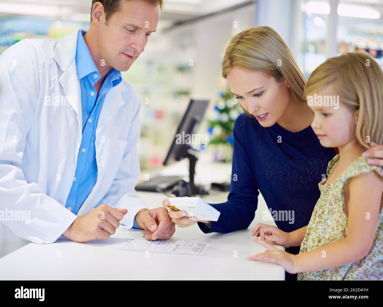 This is just what she needs. A pharmacist giving medication to a mother ...