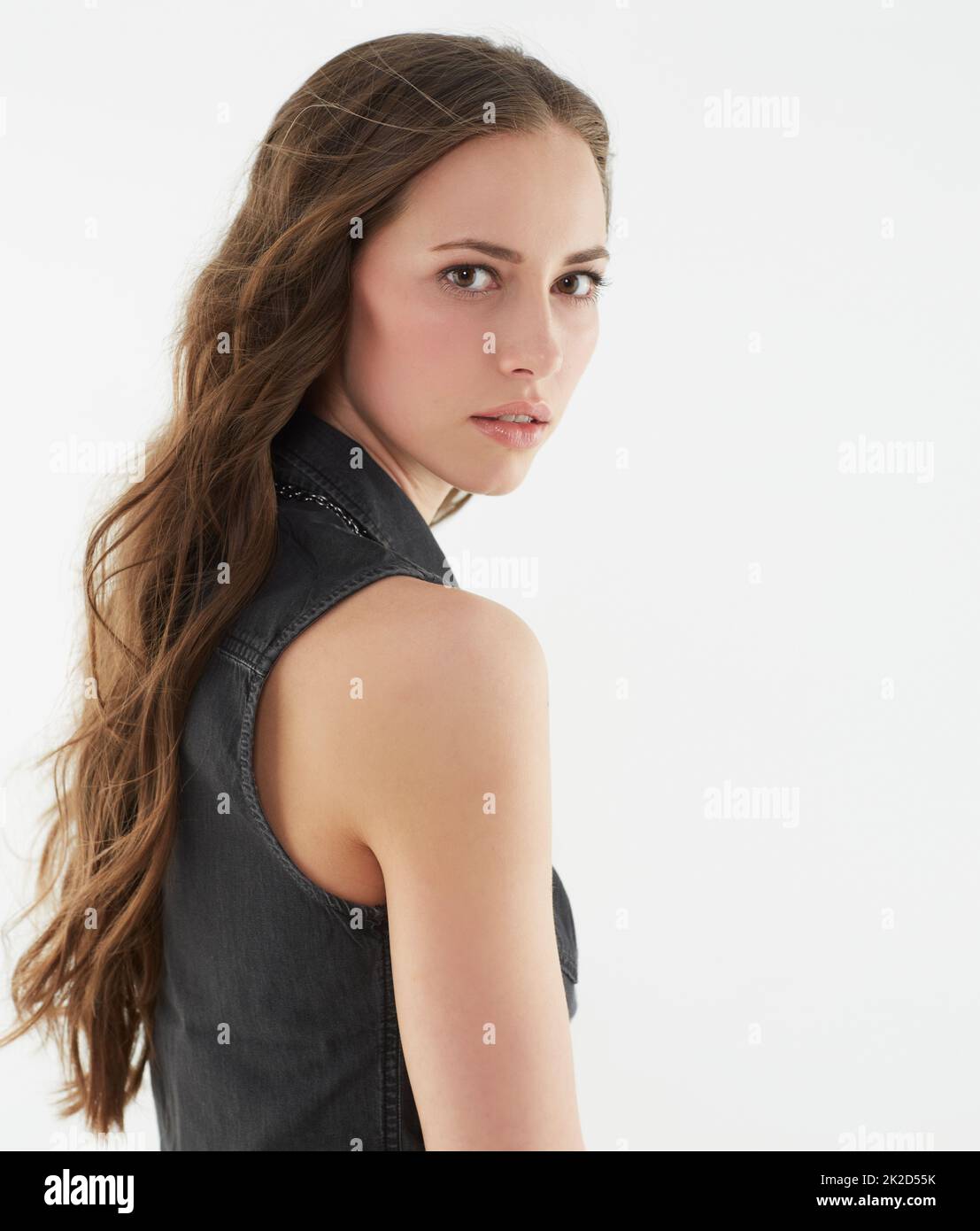 Just a little look back.... Studio shot of a young woman looking over ...