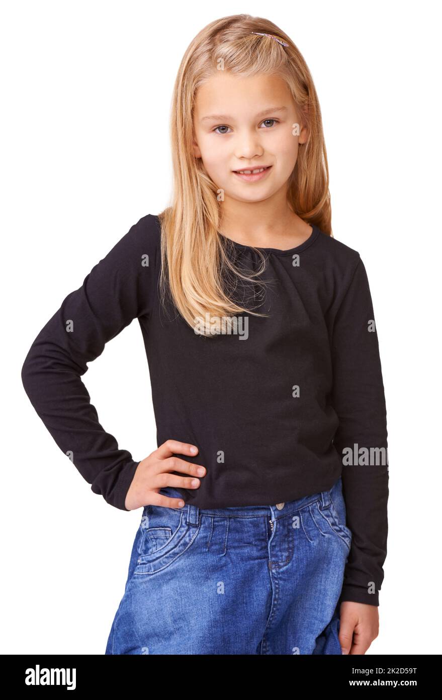 Shes a little model. A cute young girl posing against a white ...