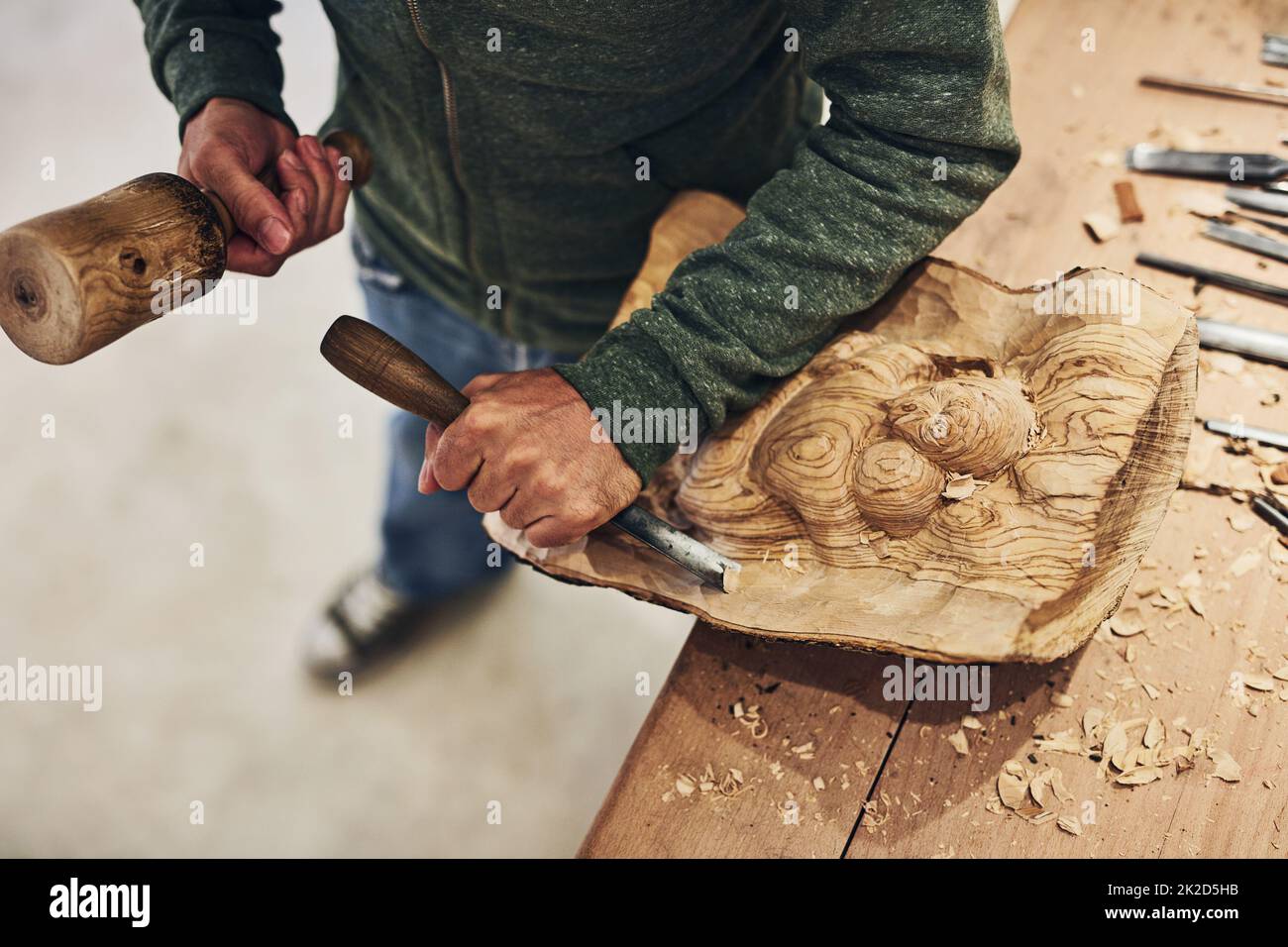 He can carve just about anything. Cropped shot of an artist carving ...