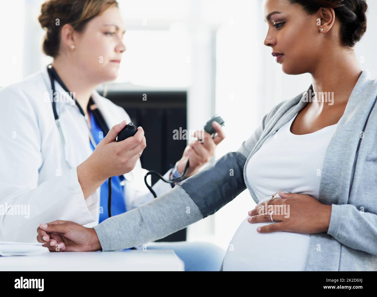 Doctor checking pregnant patient health hi-res stock photography and ...