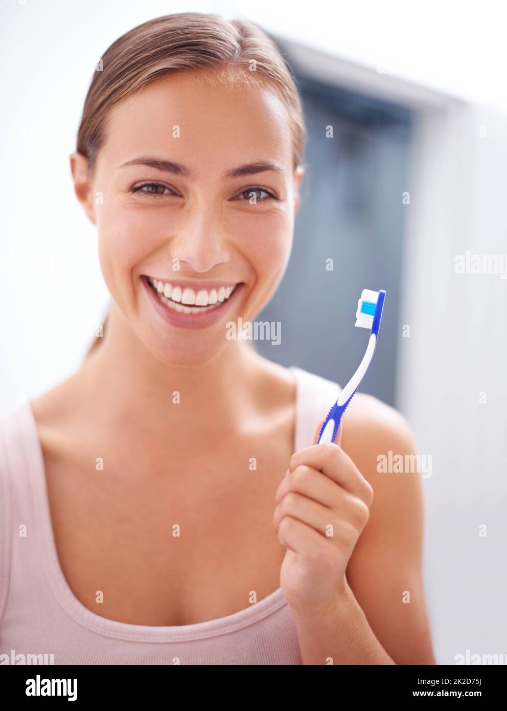 Taking care of her smile. A young woman brushing her teeth Stock Photo ...