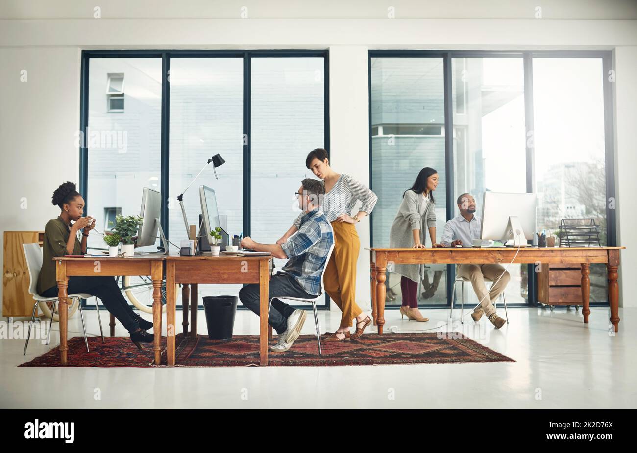 The creatives at work. Shot of a group of creatives working in a modern ...